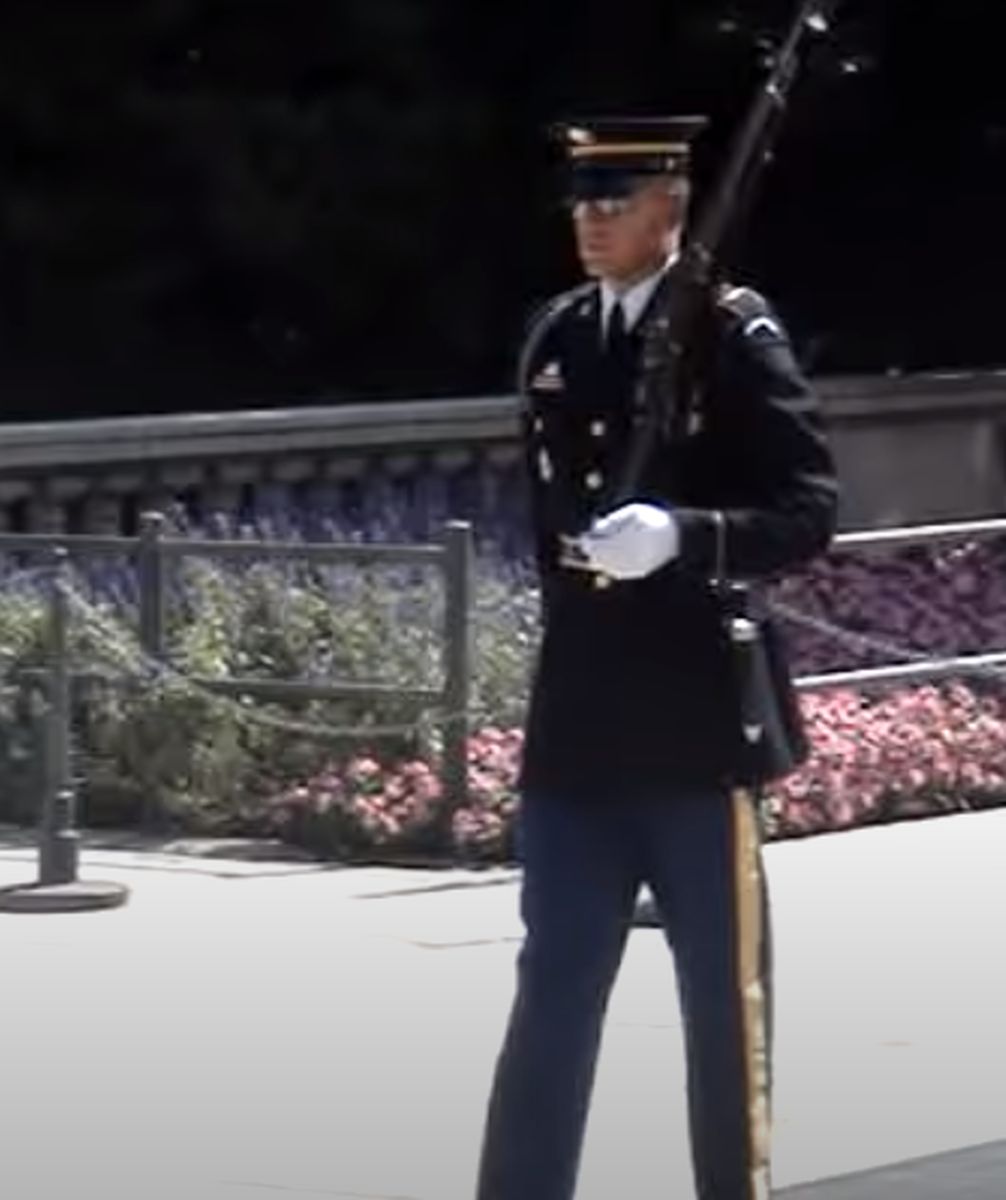Men laugh at soldier memorial and camera catches guard setting them ...