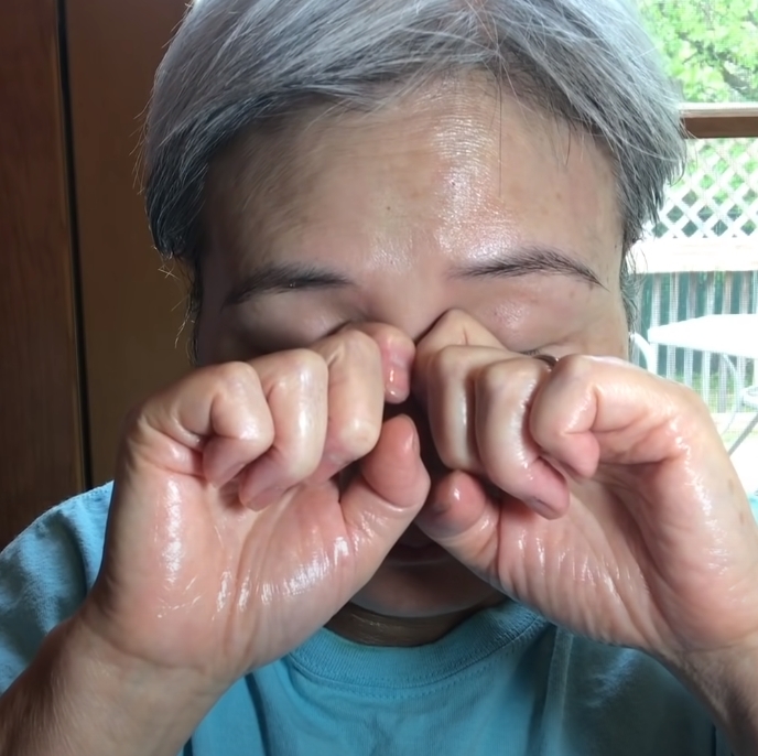 Woman shows anti-aging facial massage that promotes collagen production ...
